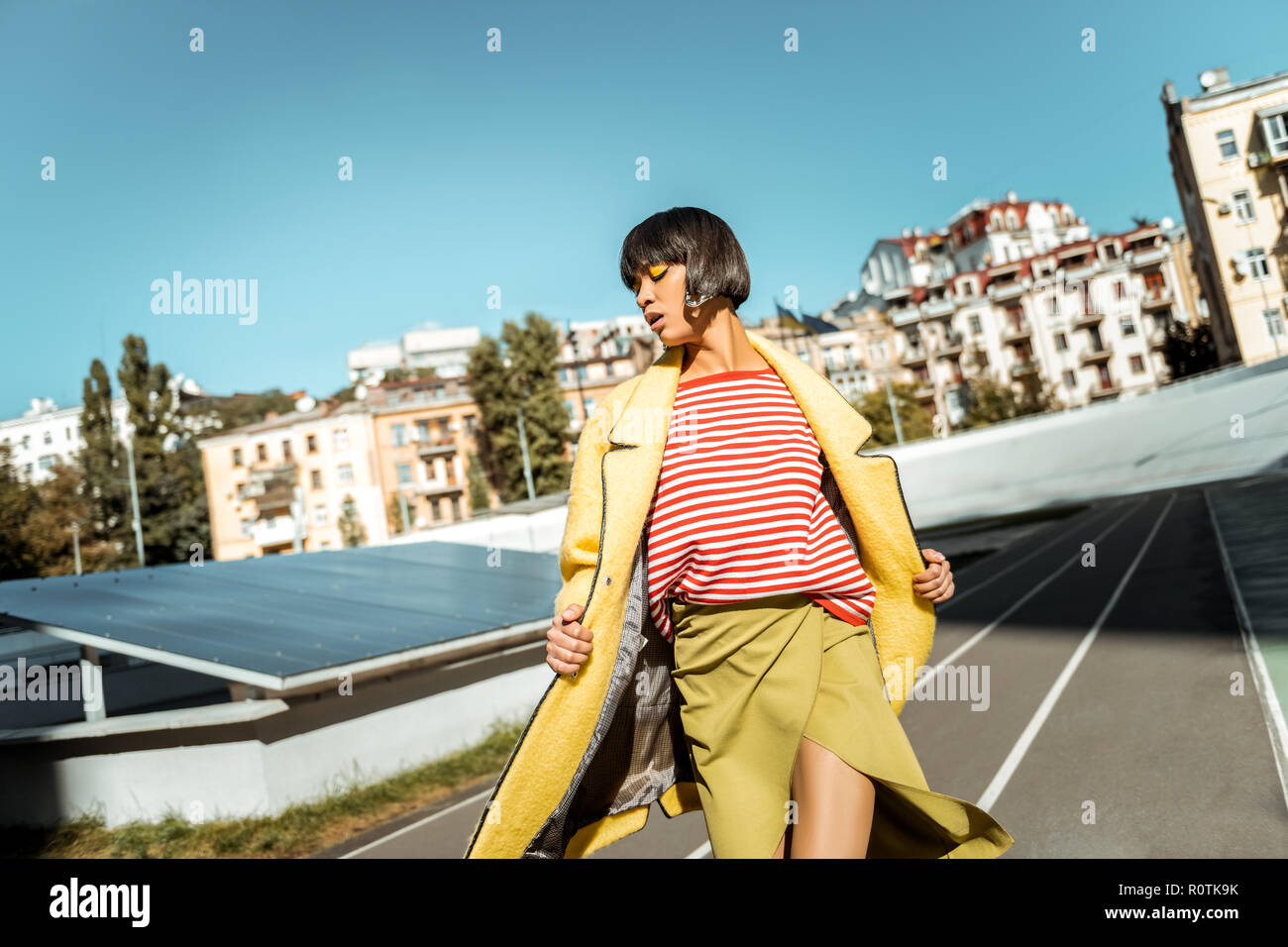 Neglectful casual female taking off her fluffy cloak Stock Photo - Alamy