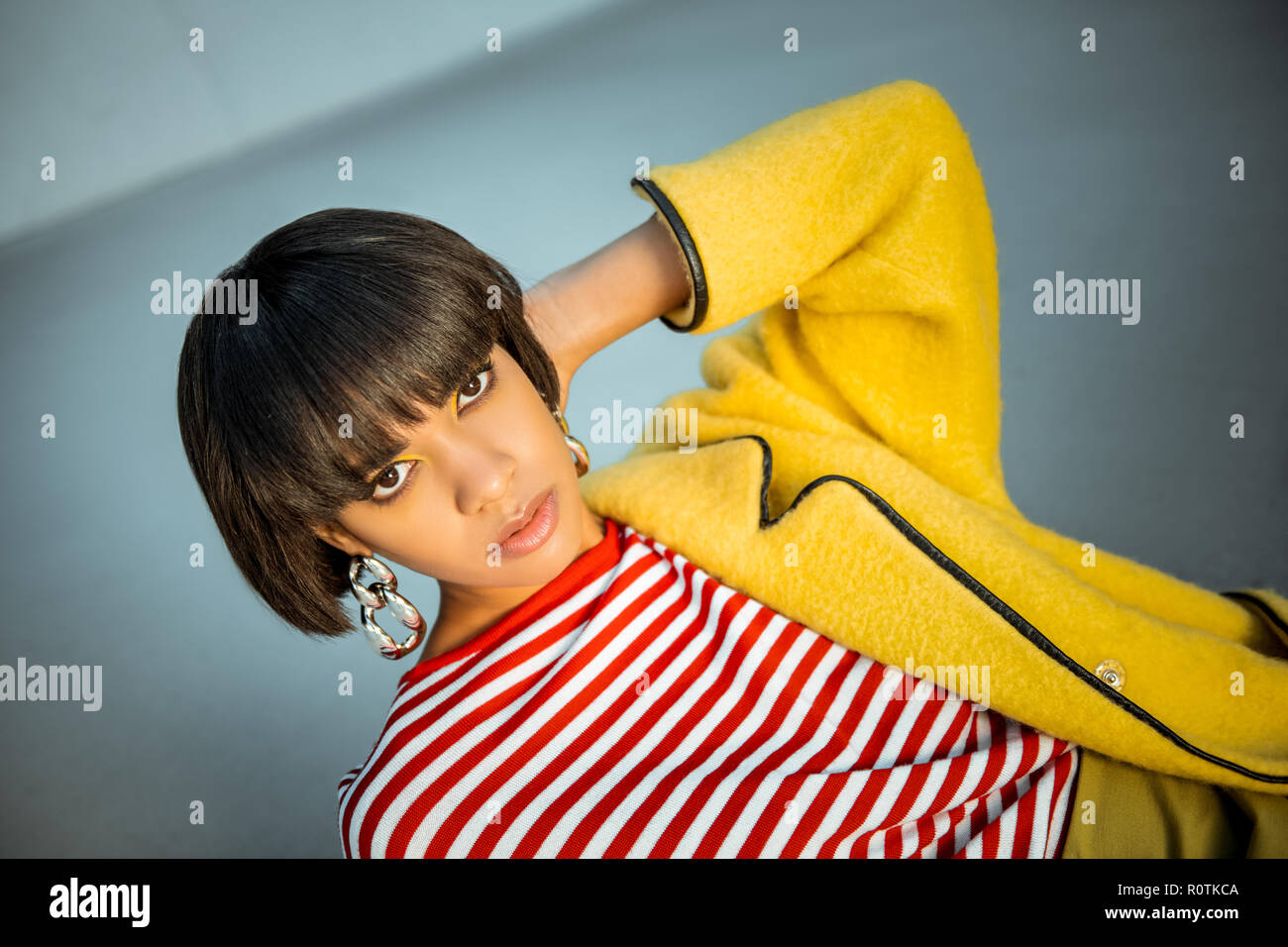 Special bronzed model throwing hand over your head Stock Photo - Alamy