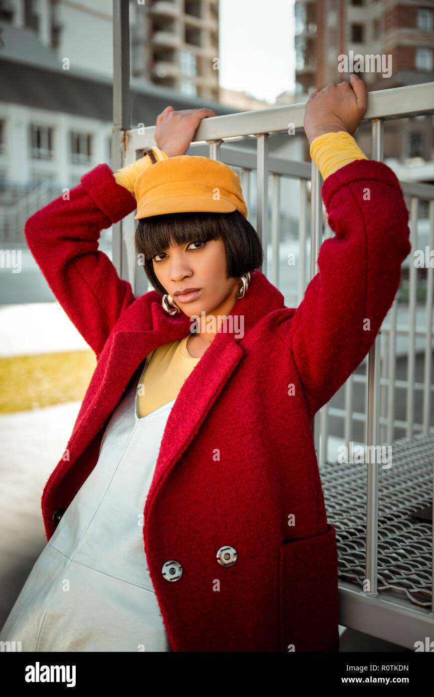 Fashionable colorful lady posing in woolen red coat Stock Photo - Alamy