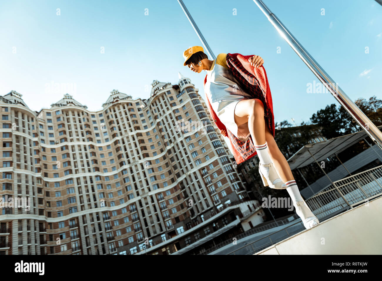 Authentic bronzed female weirdly dancing taking off her overcoat Stock ...