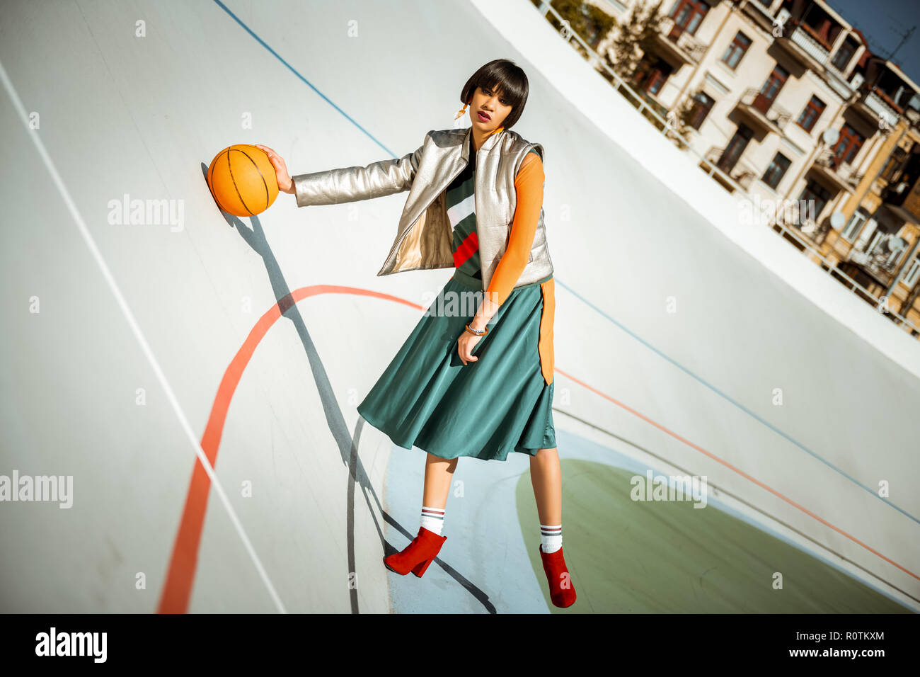 Resolute active lady standing on the stadium in layered look Stock ... Resolute active lady standing on the stadium in layered look Stock ...