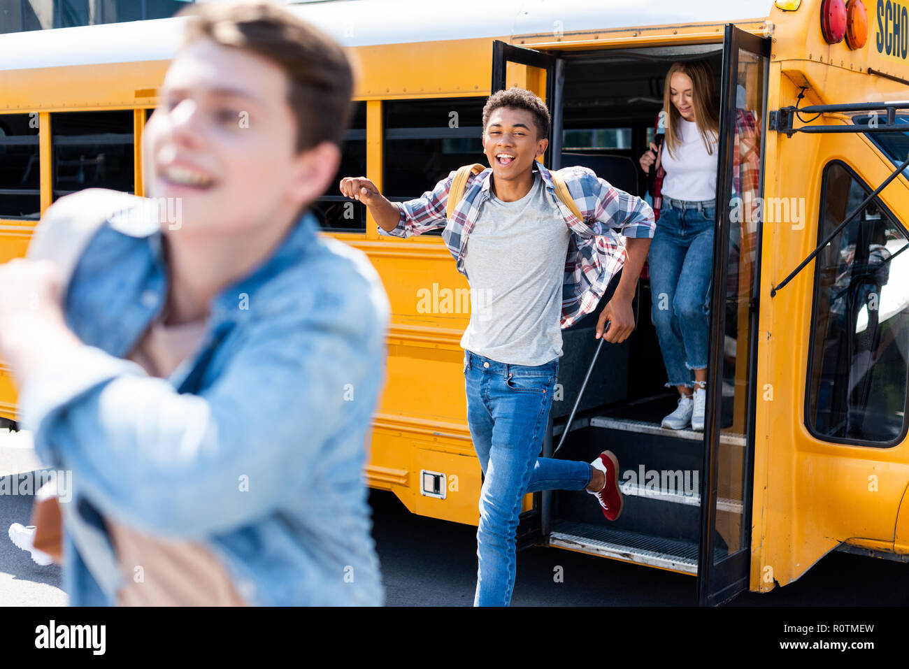 group of teen students running out of school bus Stock Photo - Alamy