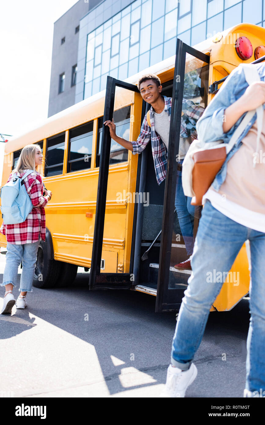 multiethnic teen students walking out of school bus Stock Photo - Alamy