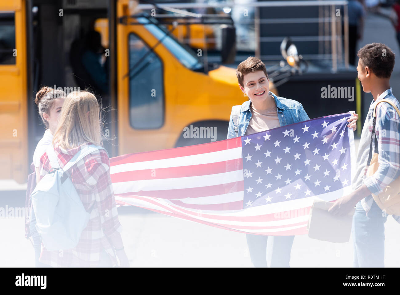 group of american teen scholars with united states flag in front of ...