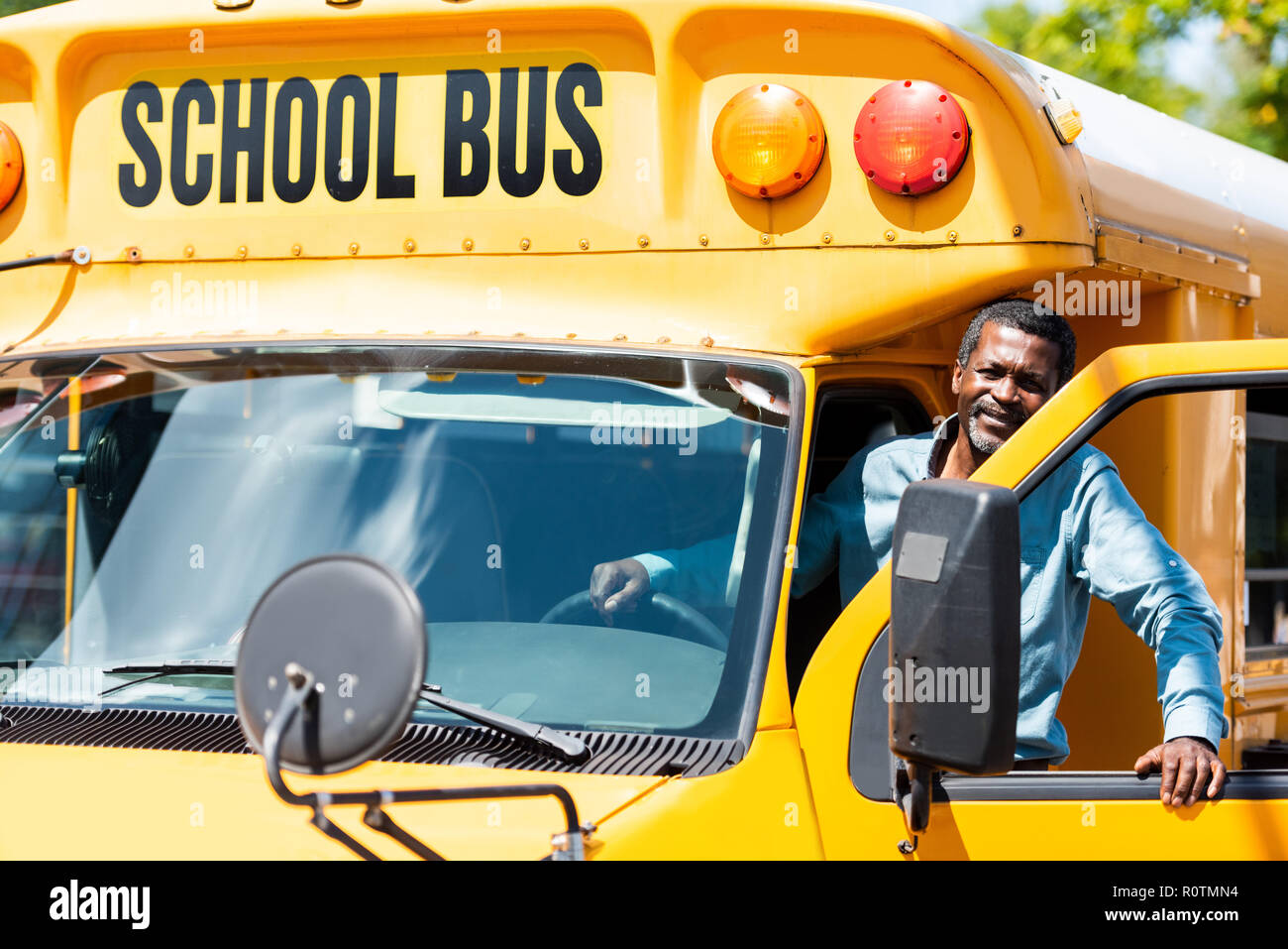 handsome senior school bus driver looking at camera Stock Photo - Alamy