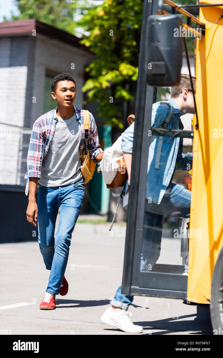 multiethnic teen schoolboys entering school bus Stock Photo - Alamy