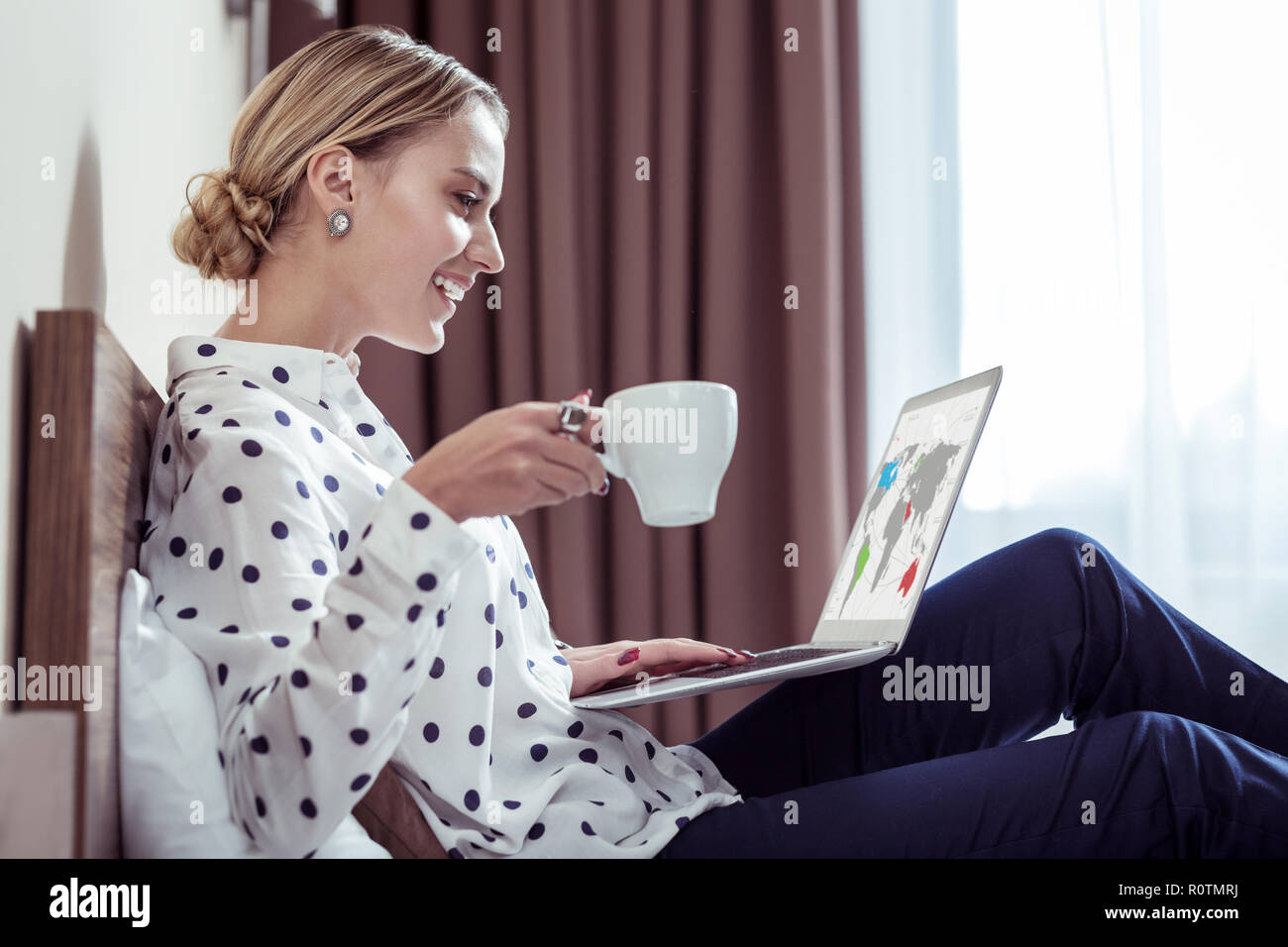 Elegant woman drinking coffee and checking working e-mail Stock Photo ...