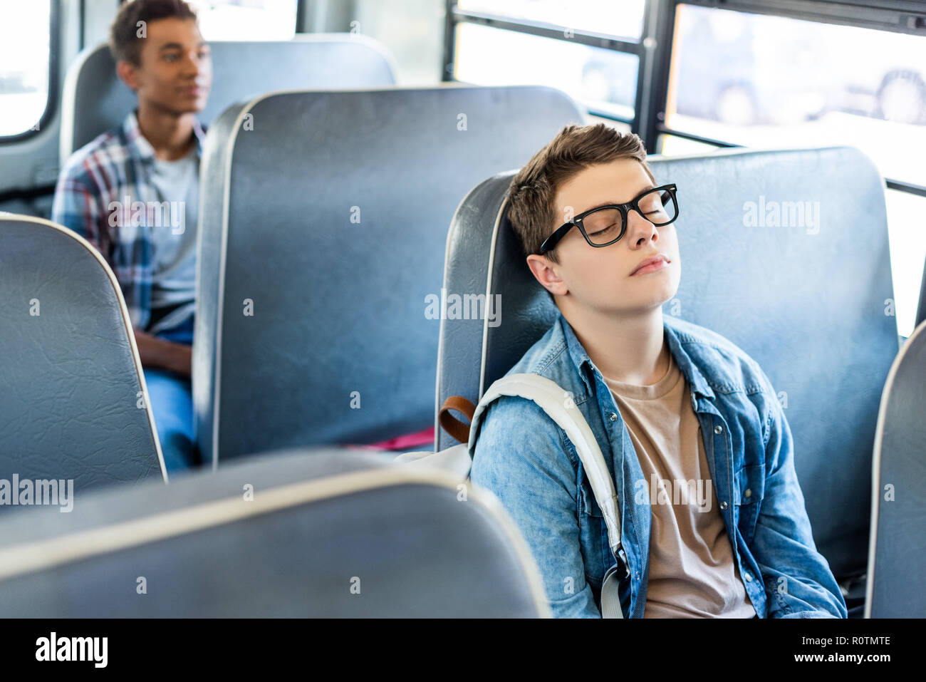 multiethnic teen schoolboys riding school bus Stock Photo - Alamy