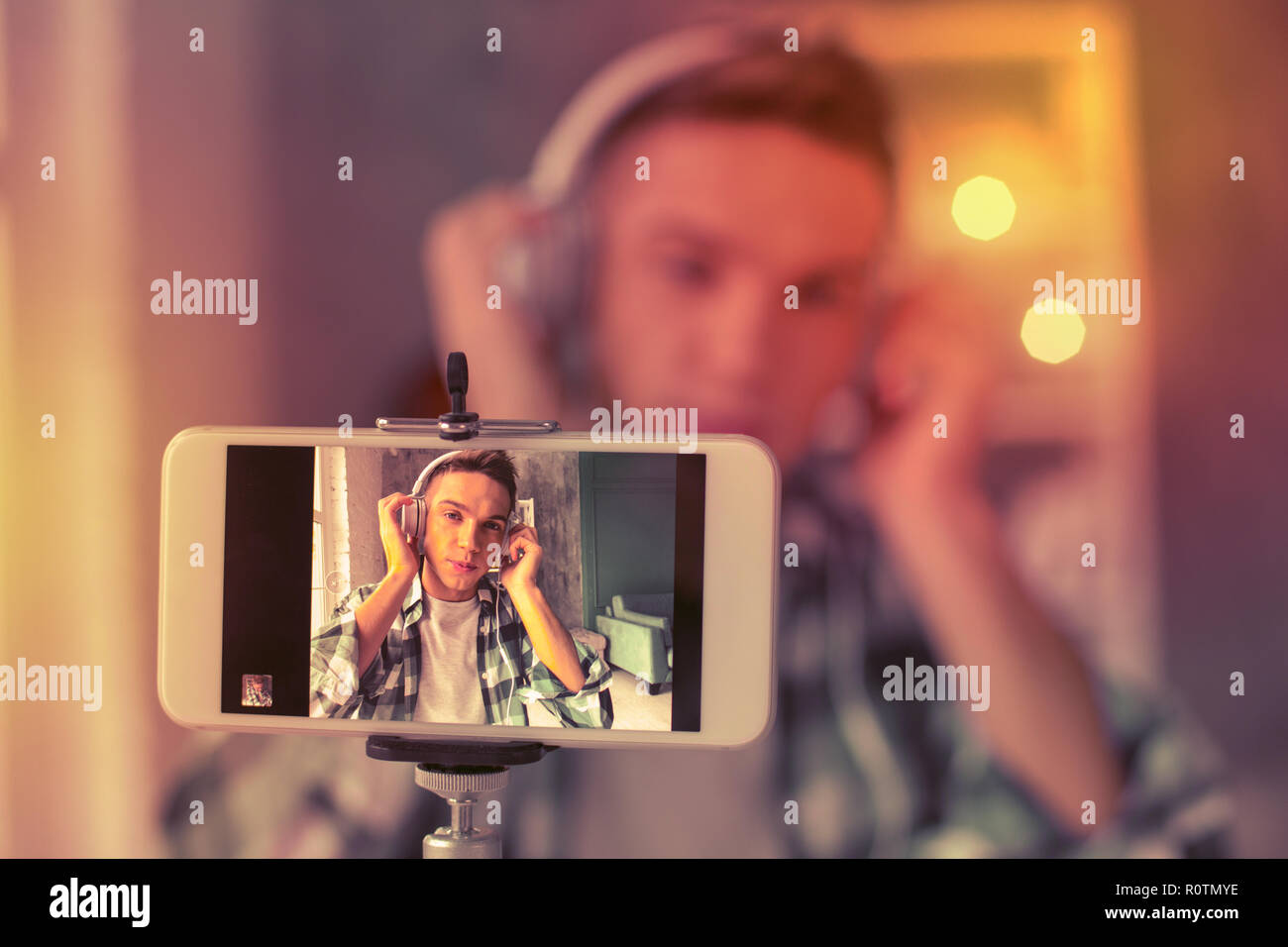 Positive young guy creating music video content Stock Photo - Alamy