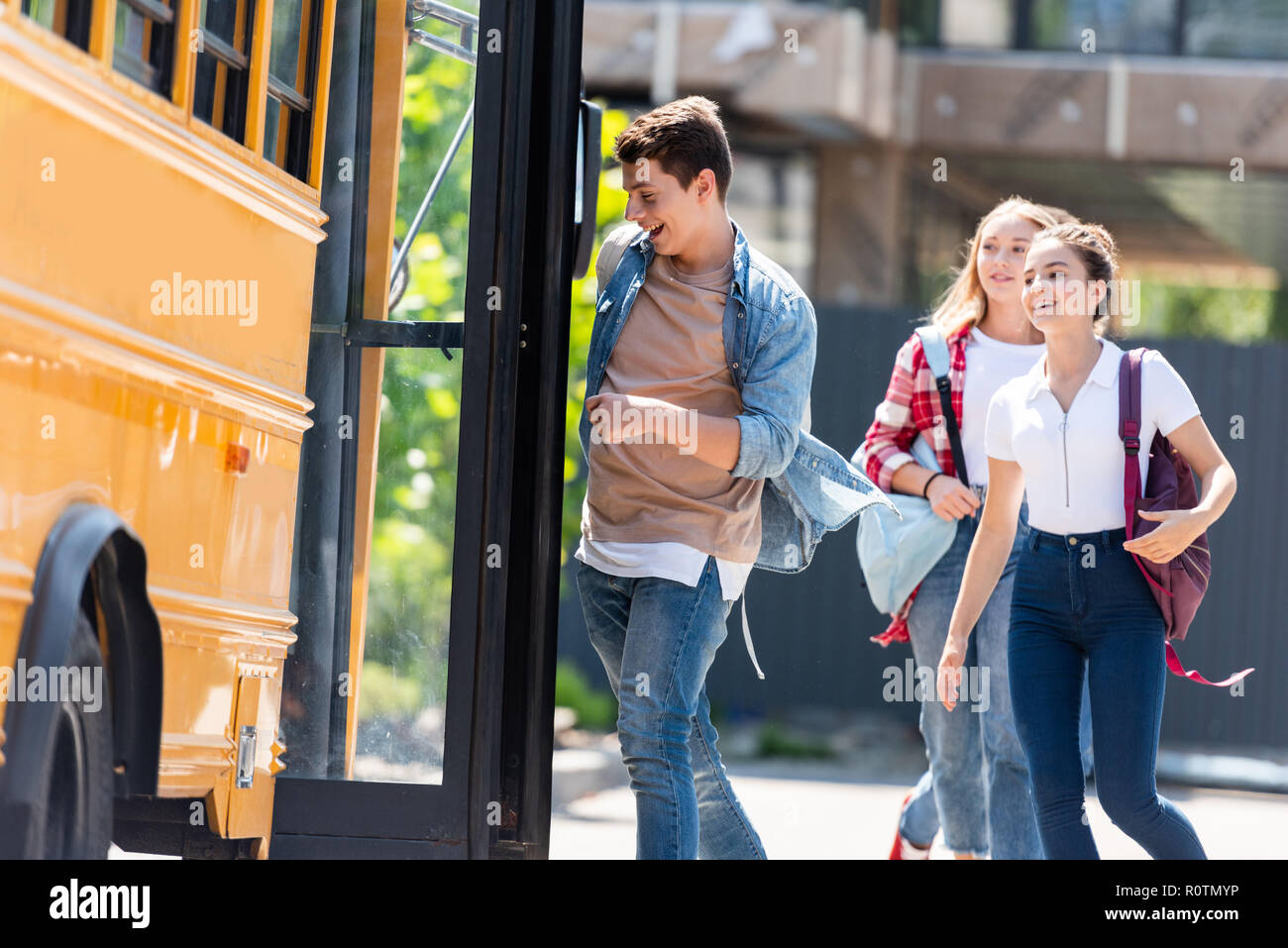 happy teen students running into school bus Stock Photo - Alamy