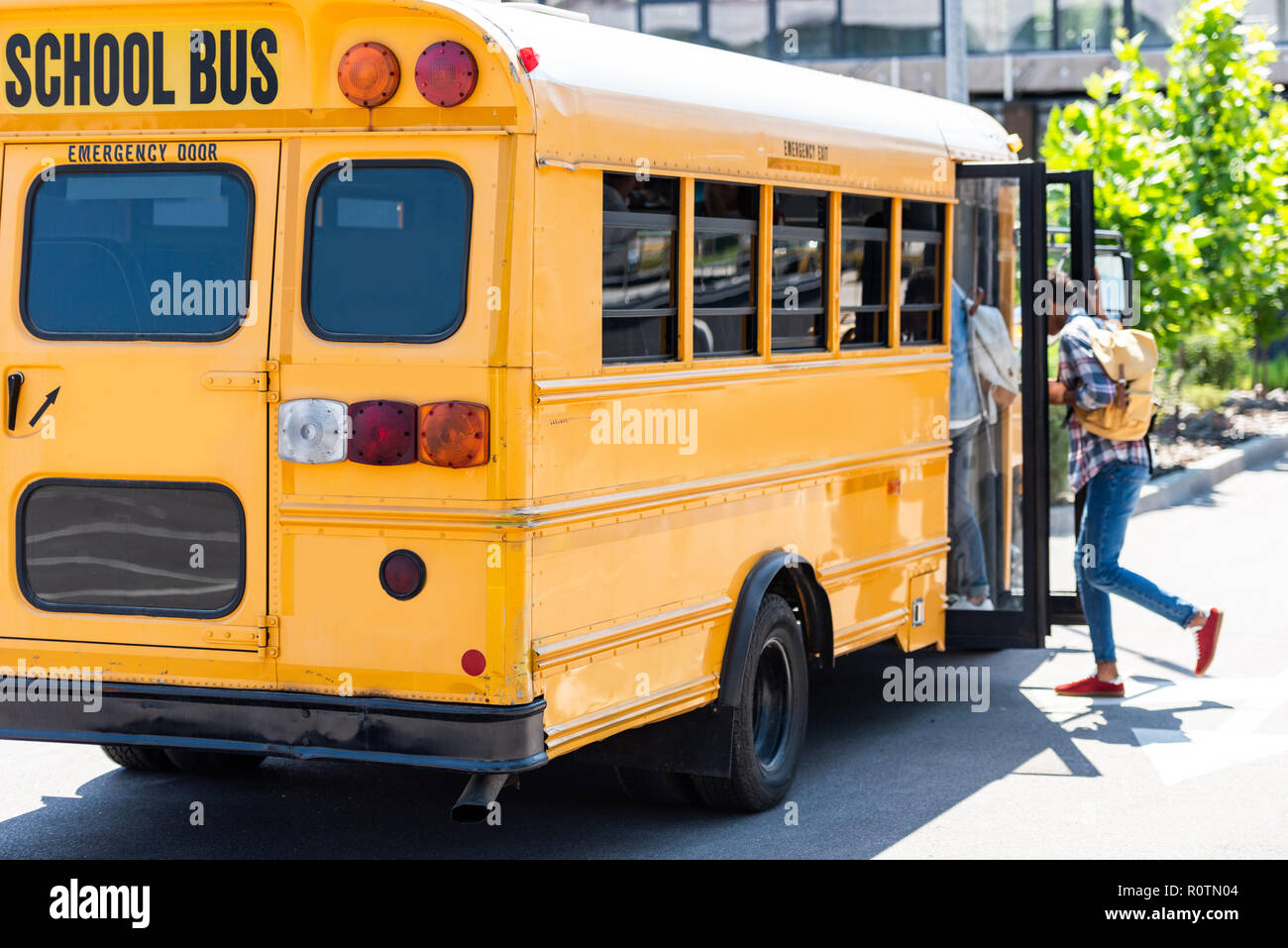 students walking into school bus at parking Stock Photo - Alamy