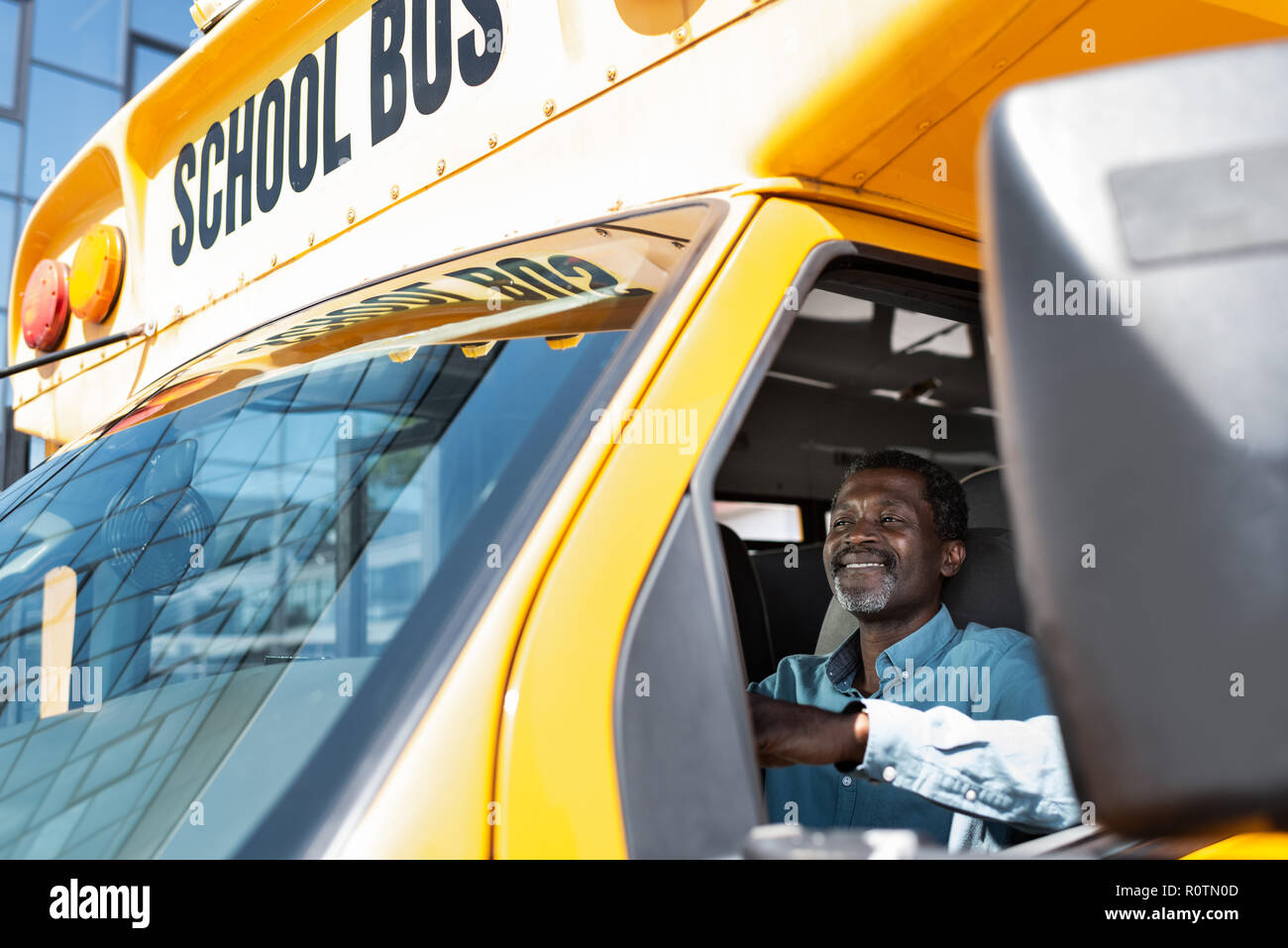 view through side window at mature african american bus driver Stock ...