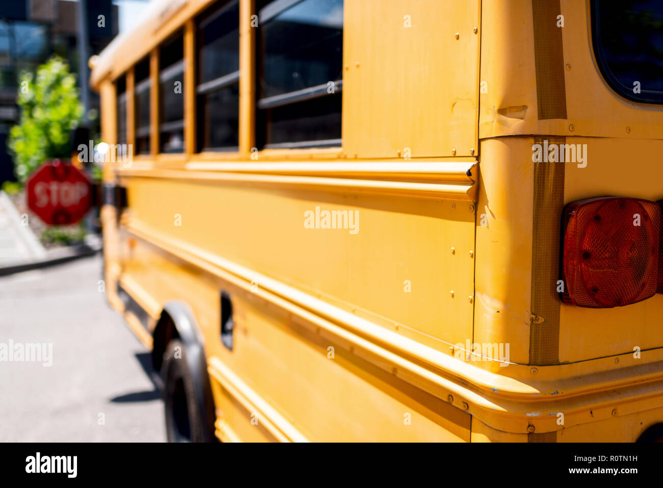 partial view of traditional school bus with stop sign Stock Photo - Alamy