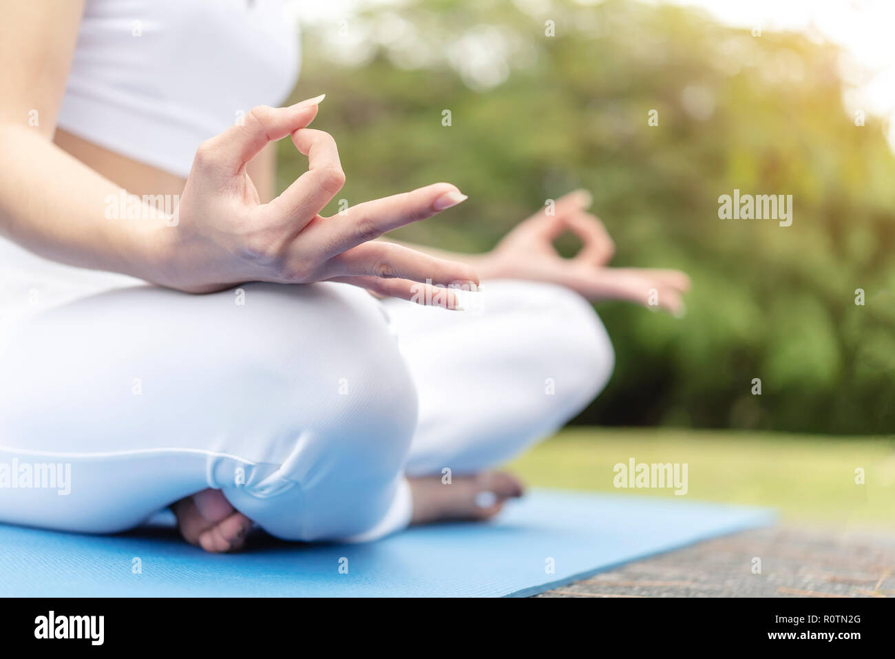 Closeup woman doing yoga finger acting with nature soft focus ...