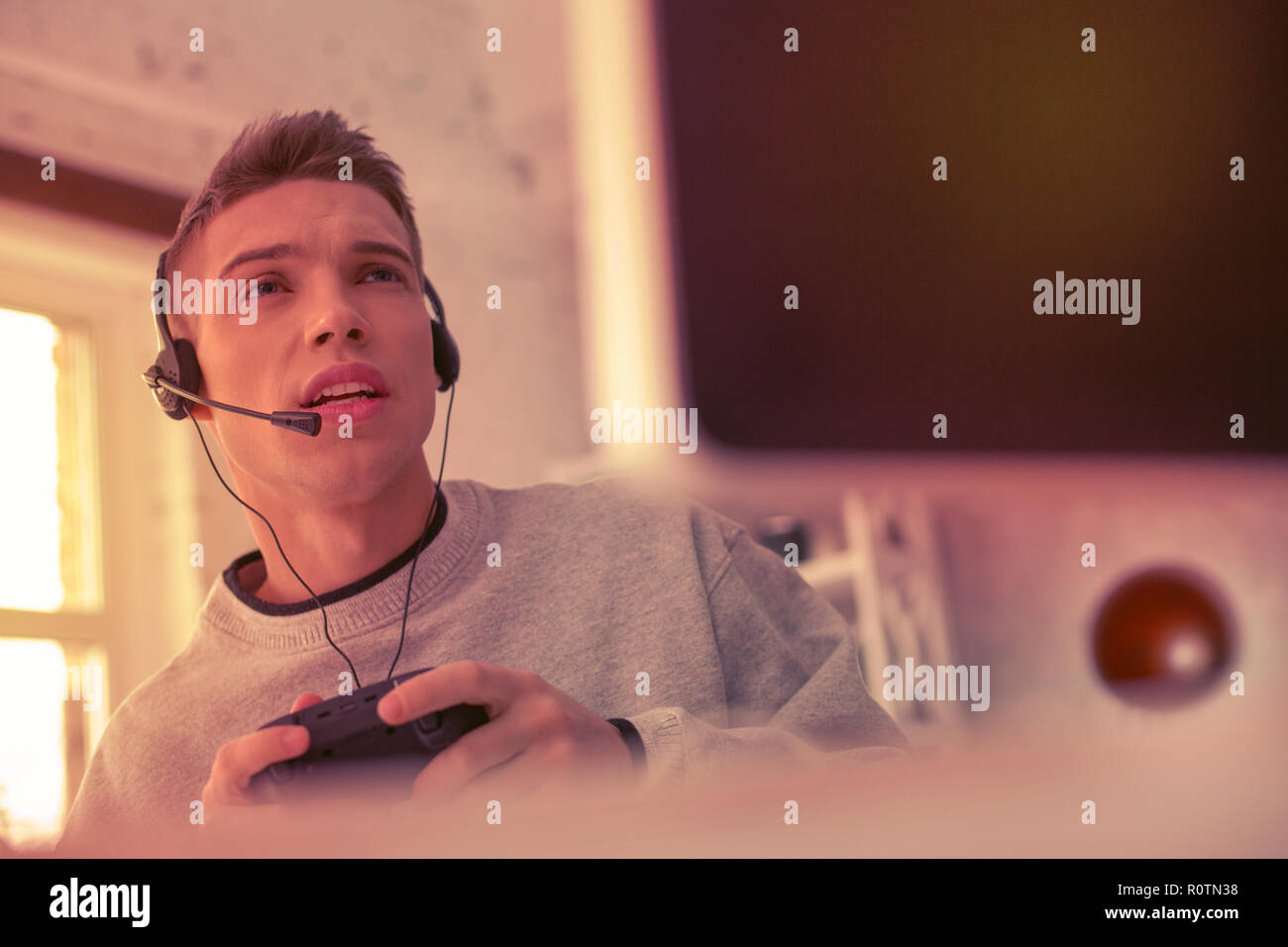 Discouraged young man looking on the screen Stock Photo - Alamy