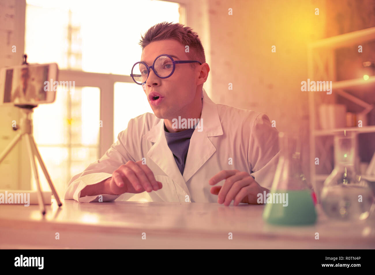 Curious blogger excitedly speaking to the camera Stock Photo - Alamy