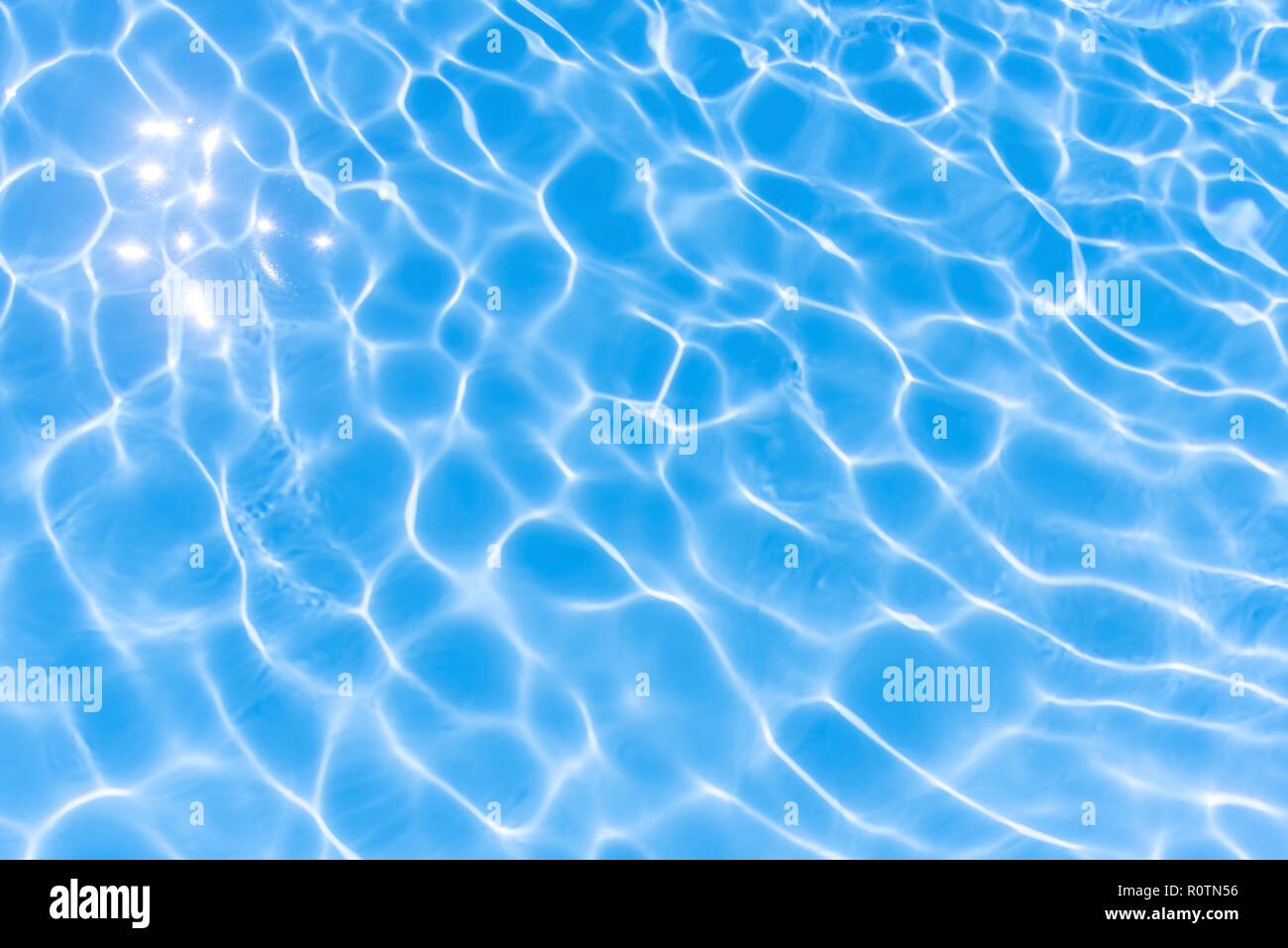 Water wave with reflection of sunlight in pool or sea. Travel, summer ...