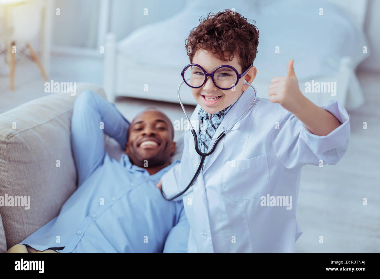 Happy smart young boy showing OK sign Stock Photo - Alamy