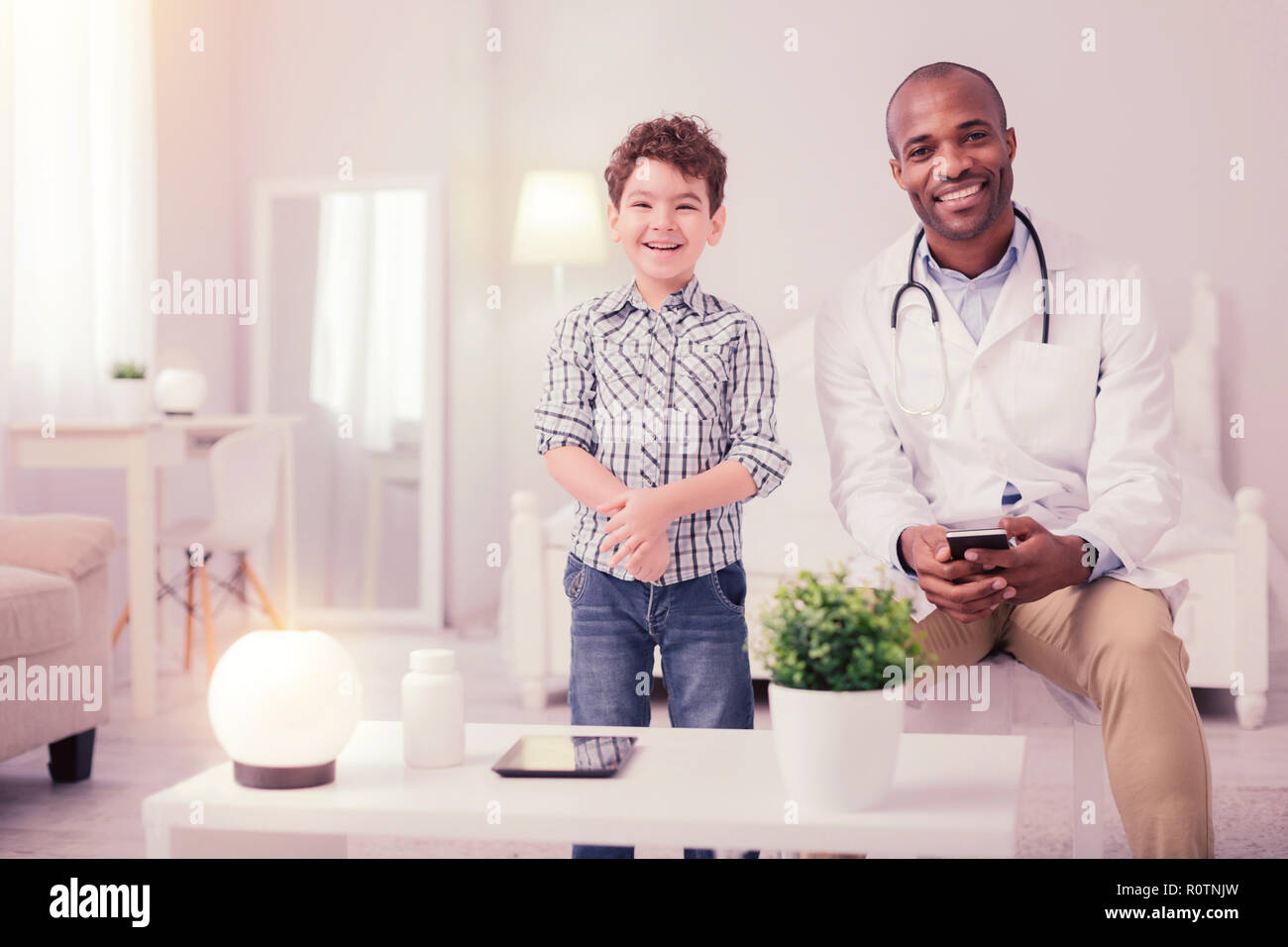 Joyful positive doctor and patient looking at you Stock Photo - Alamy