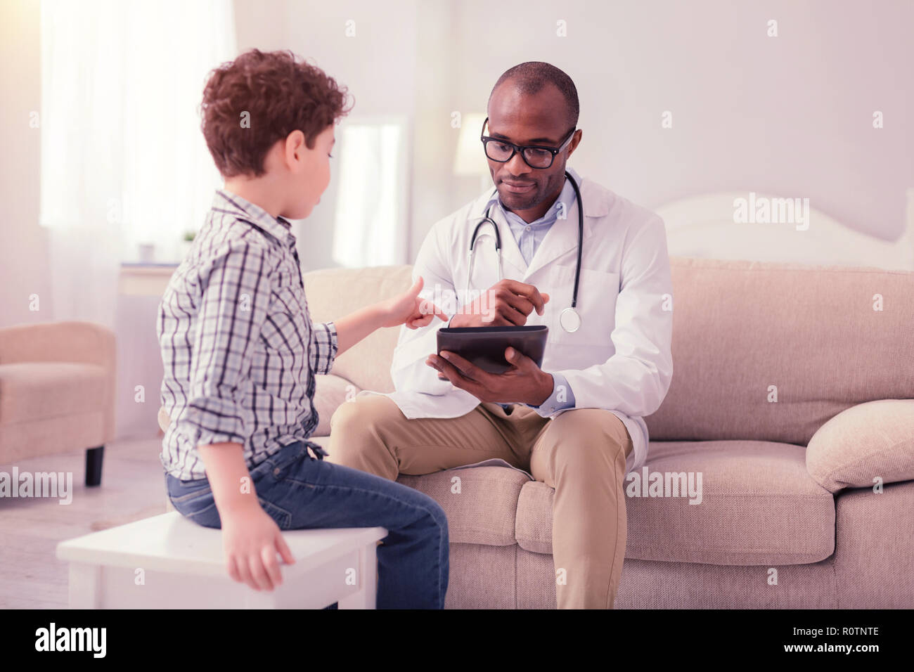 Smart intelligent doctor holding his digital device Stock Photo - Alamy