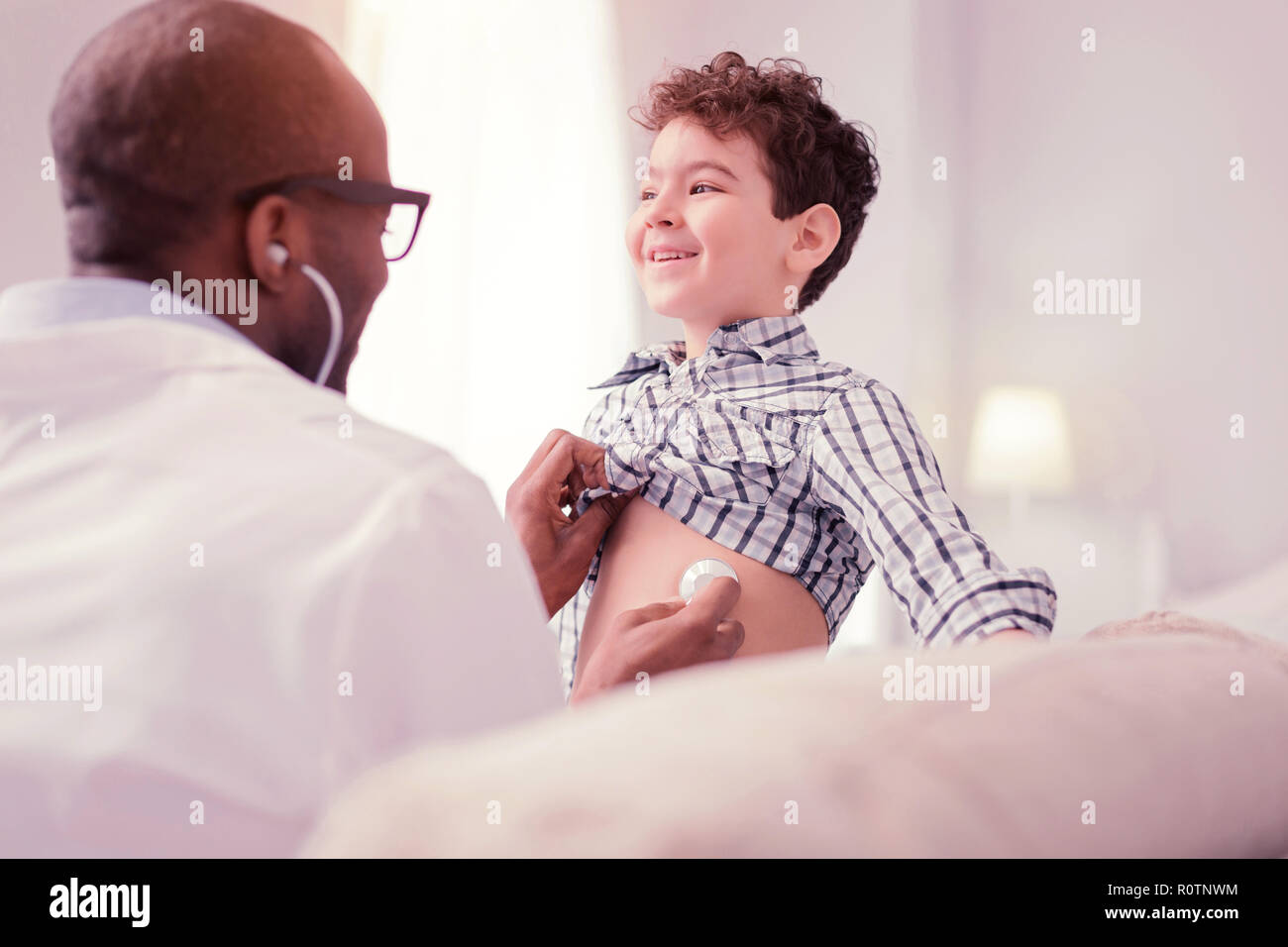 Nice cute boy having a medical checkup Stock Photo - Alamy