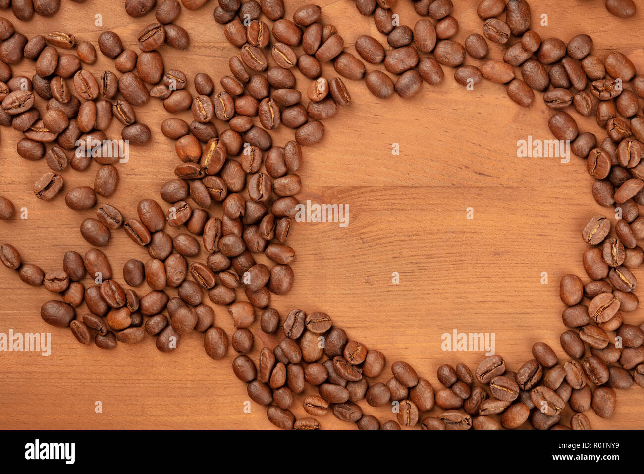 An overhead photo of coffee beans forming a frame for copy space, toned ...