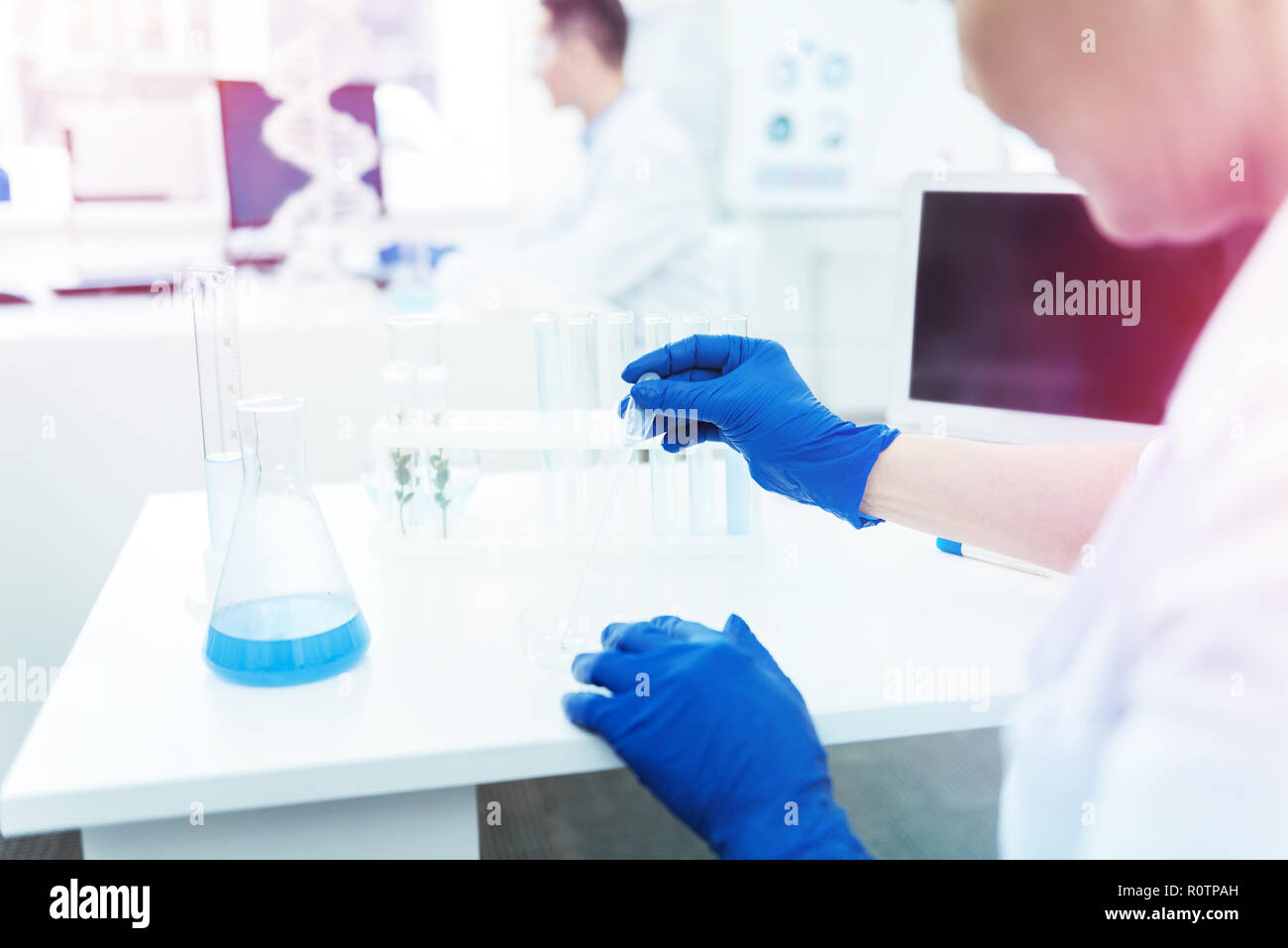 Professional female scientist wearing blue rubber gloves Stock Photo ...