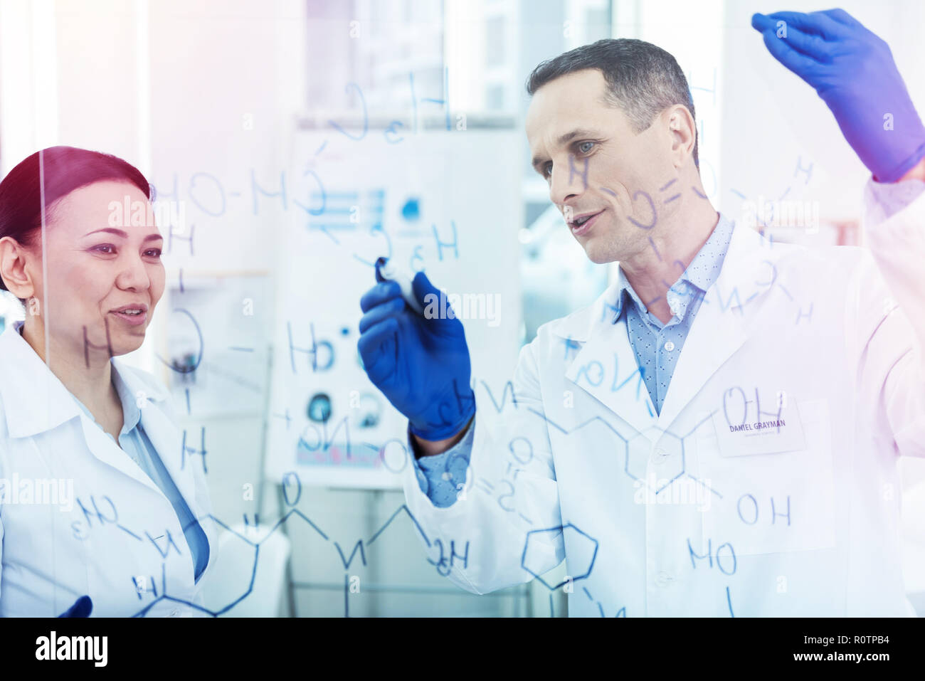 Positive intelligent chemists discussing a chemical formula Stock Photo ...