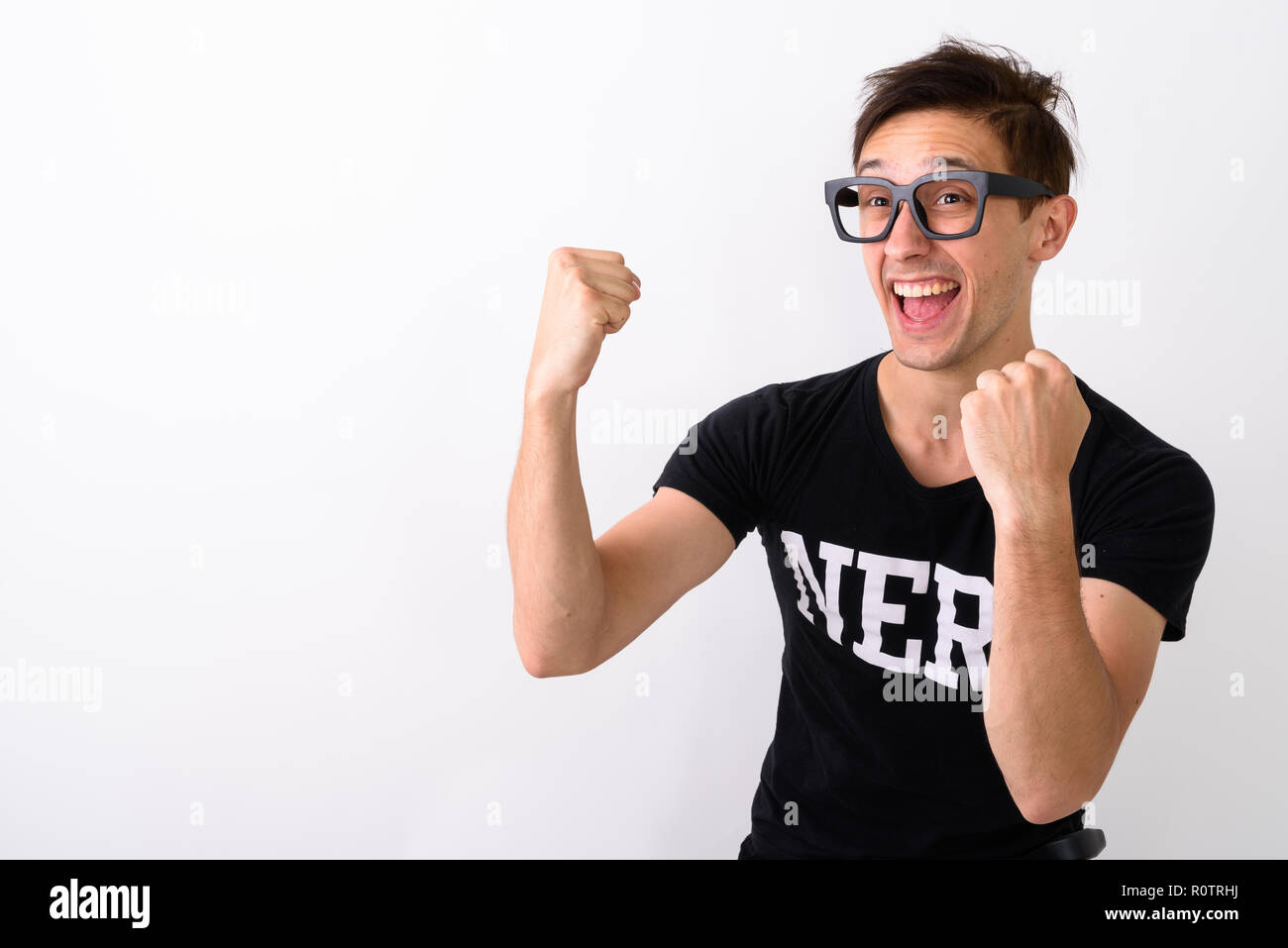 Studio shot of young happy nerd man smiling while thinking and l Stock ...