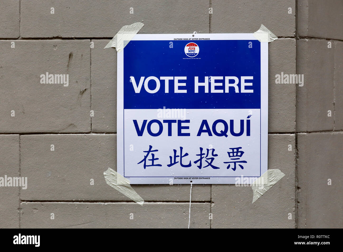 A trilingual Vote Here sign outside a polling site in New York City ...