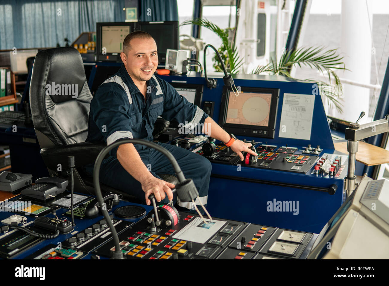 Marine navigational officer is maneuvering ship or vessel Stock Photo ...