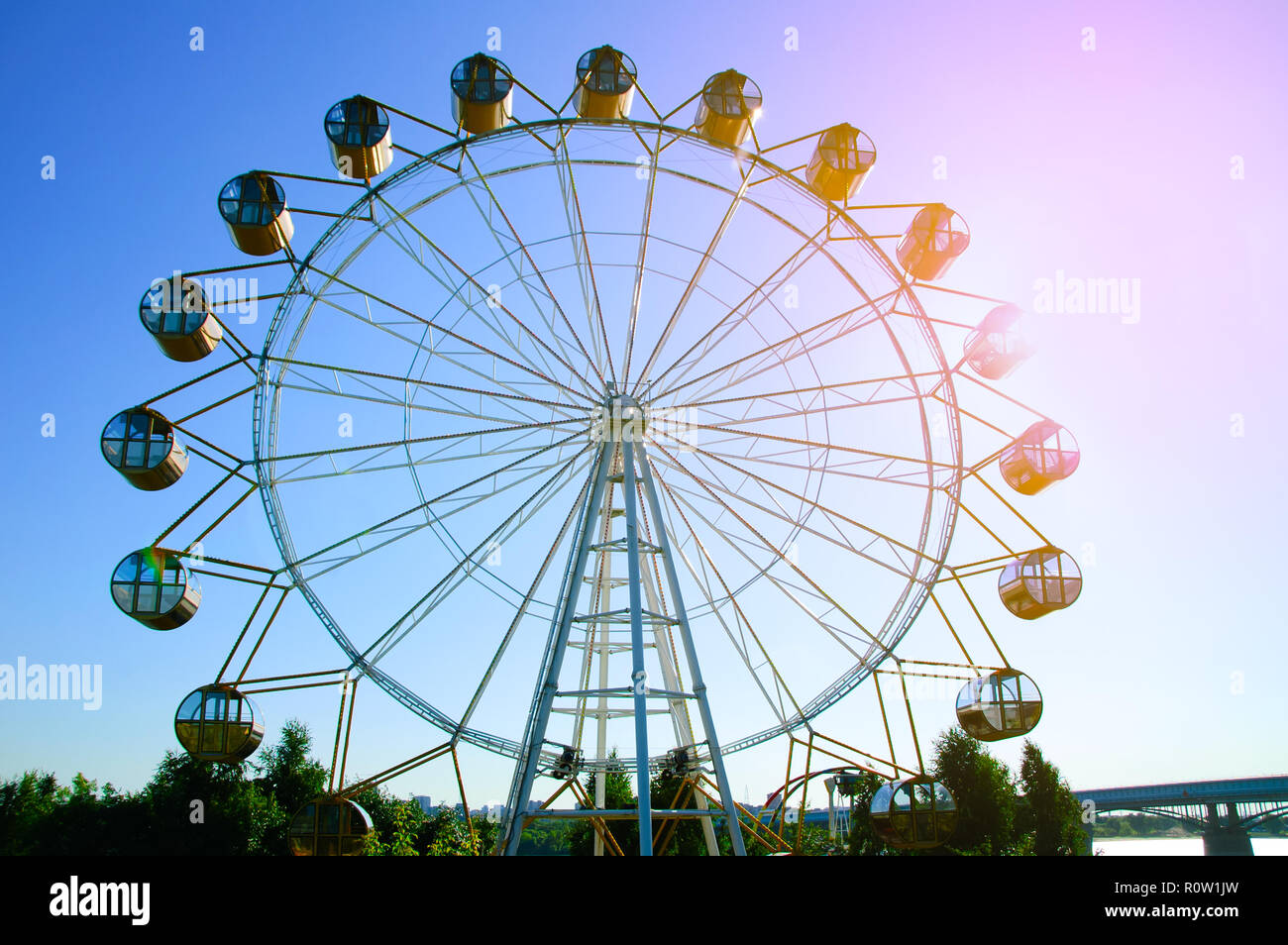 Ferris wheel in the amusement park. On the Sunset Stock Photo - Alamy