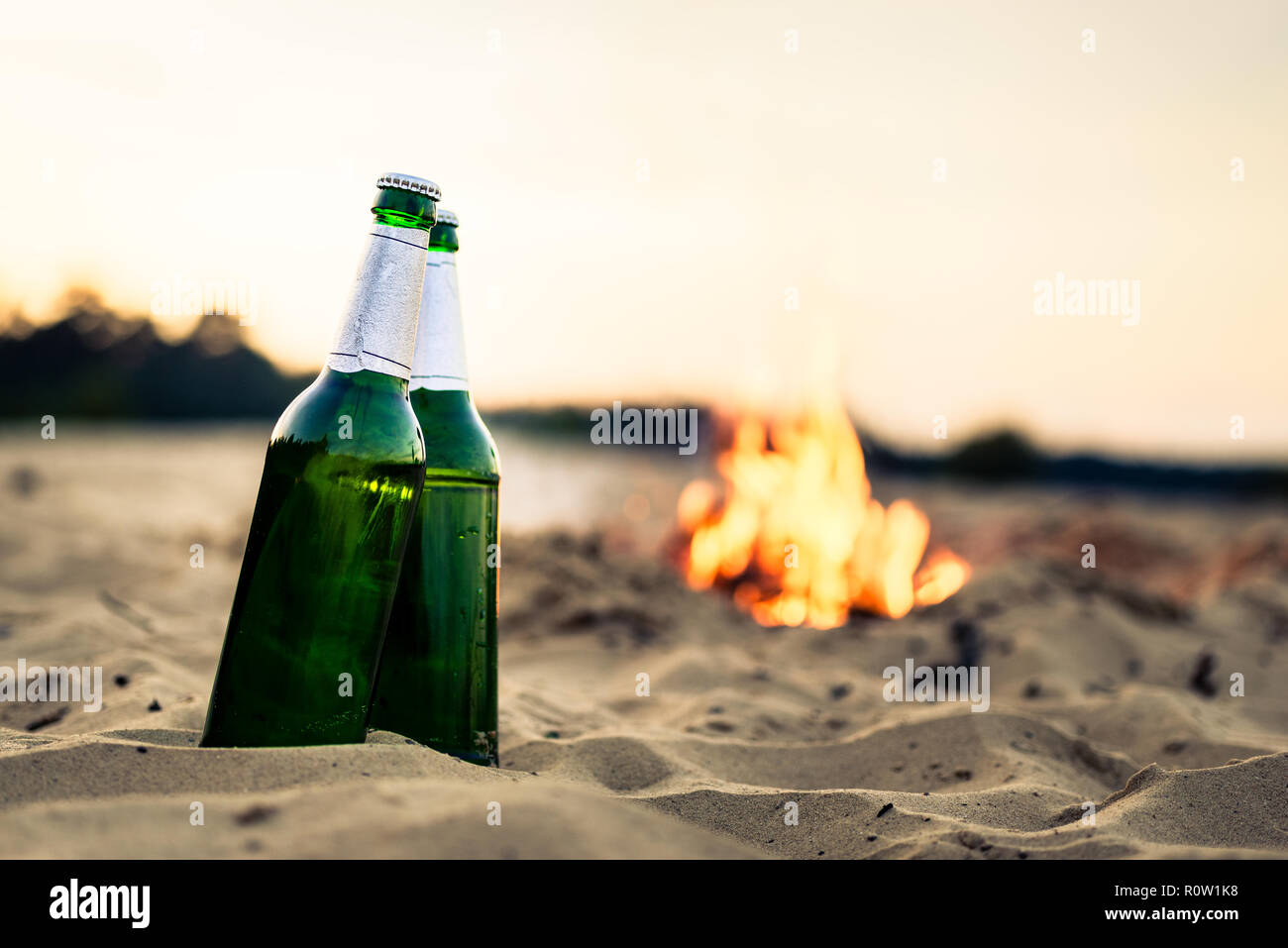 Two alcohol bottles on beach Stock Photo - Alamy
