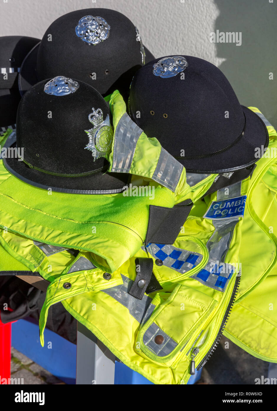 Three traditional male police officers helmets of Cumbria Constabulary ...