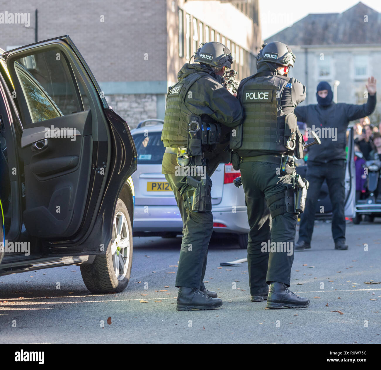 Armed Firearms Police officers demonstrating a vehicle stop and arrest ...