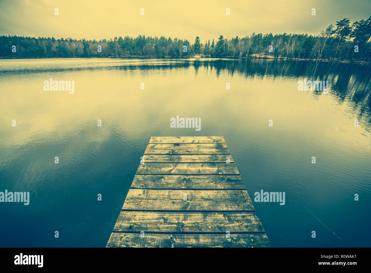 Beautiful lake landscape with romantic wooden pier or wooden jetty over ...