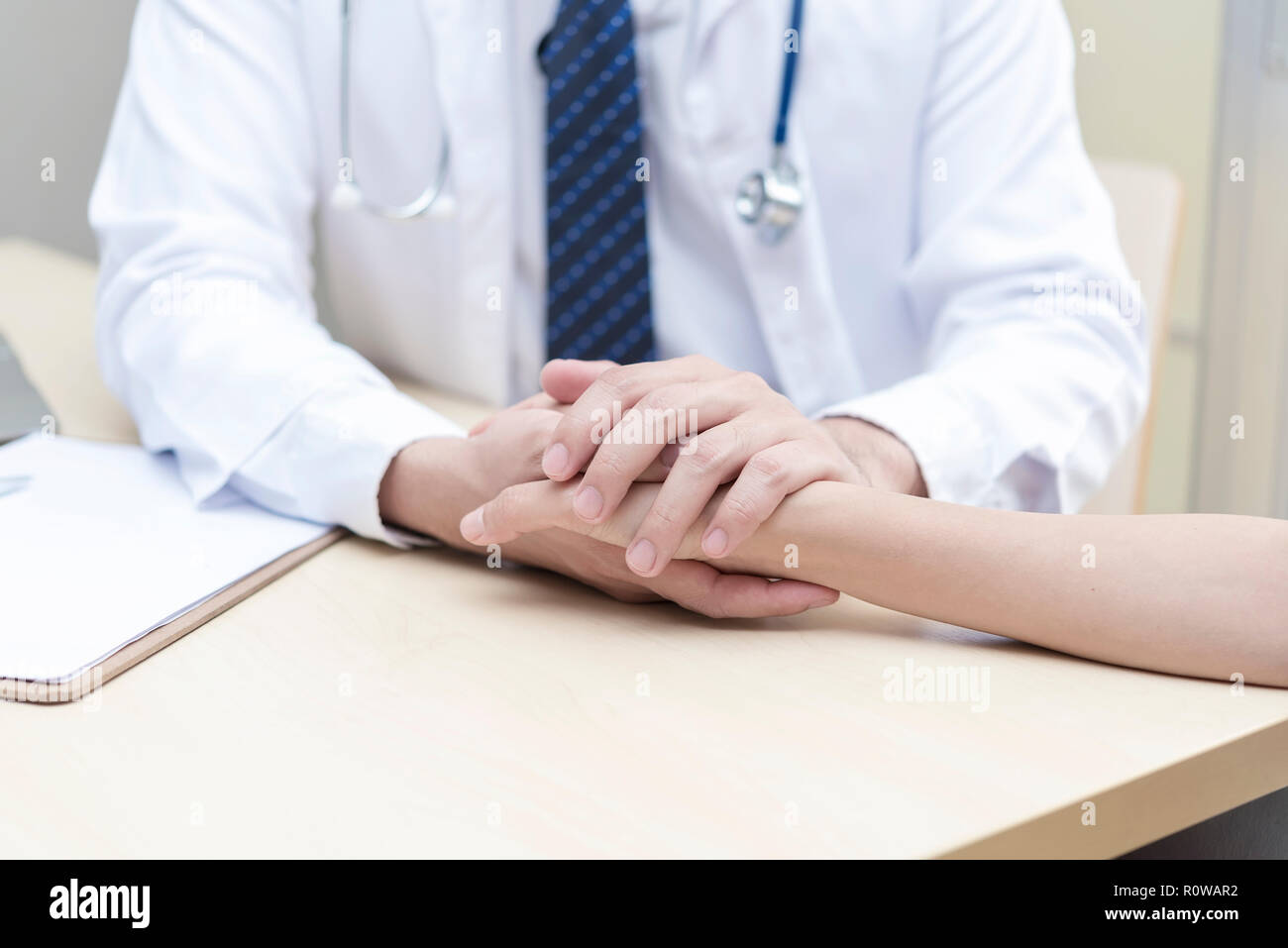 Doctor holding patient hand hi-res stock photography and images - Alamy