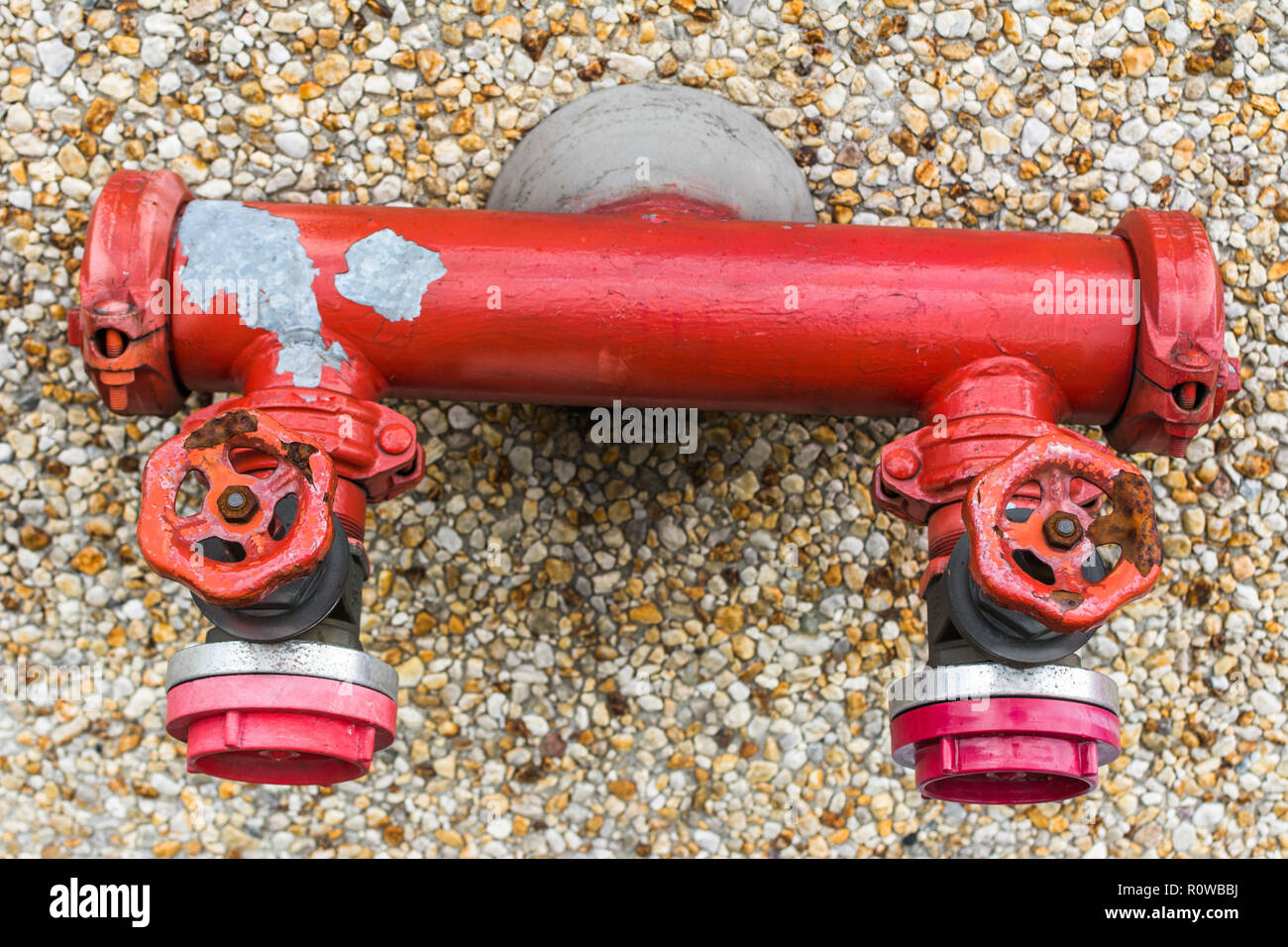 Industrial fire hydrant in a stone wall, standpipe or fireplug Stock ...