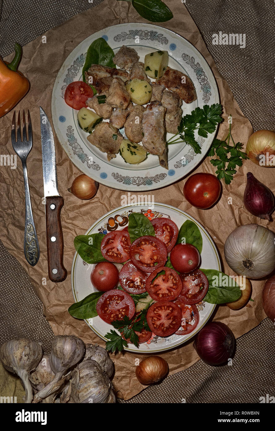 Meat and potatoes and tomato salad. Still life top view Stock Photo - Alamy