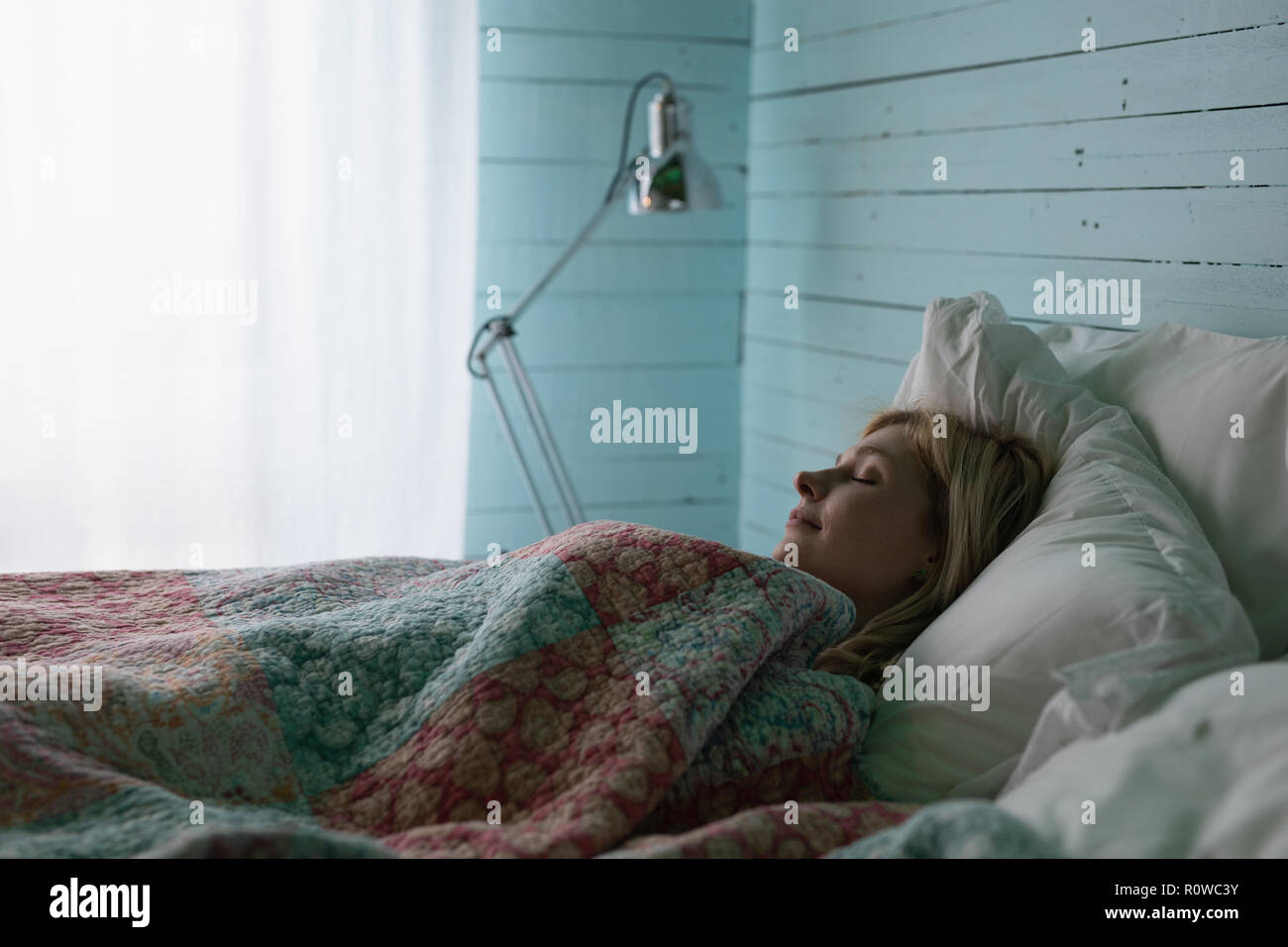 Woman sleeping in bedroom at home Stock Photo - Alamy