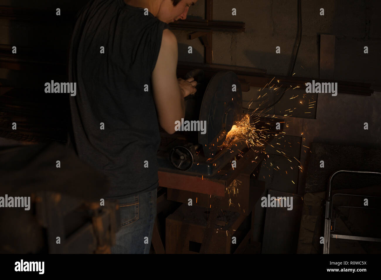 Female metalsmith using metal cutter machine Stock Photo - Alamy