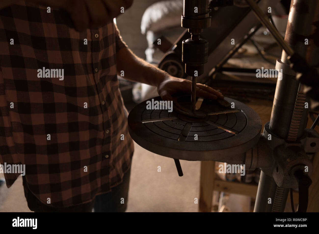 Female metalsmith using radial drilling machine in factory Stock Photo ...