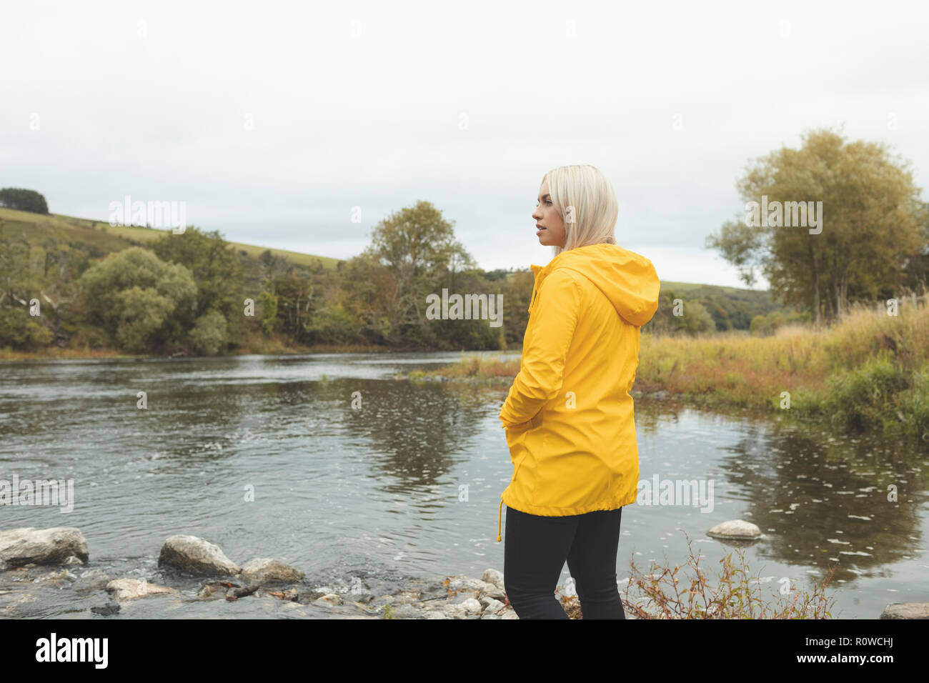 Woman standing by river hi-res stock photography and images - Alamy