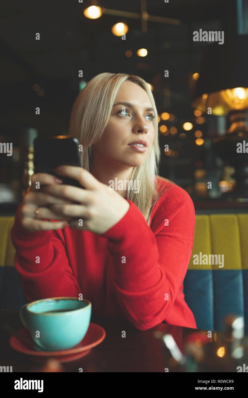 Girl using smartphone sitting table hi-res stock photography and images ...
