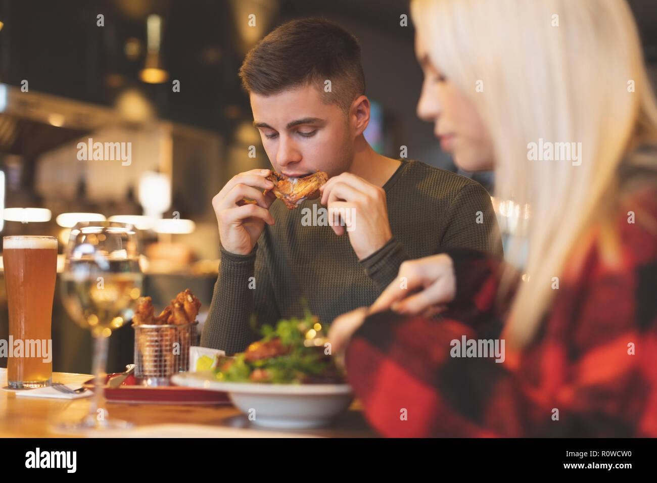 Couple eating food in restaurant Stock Photo - Alamy