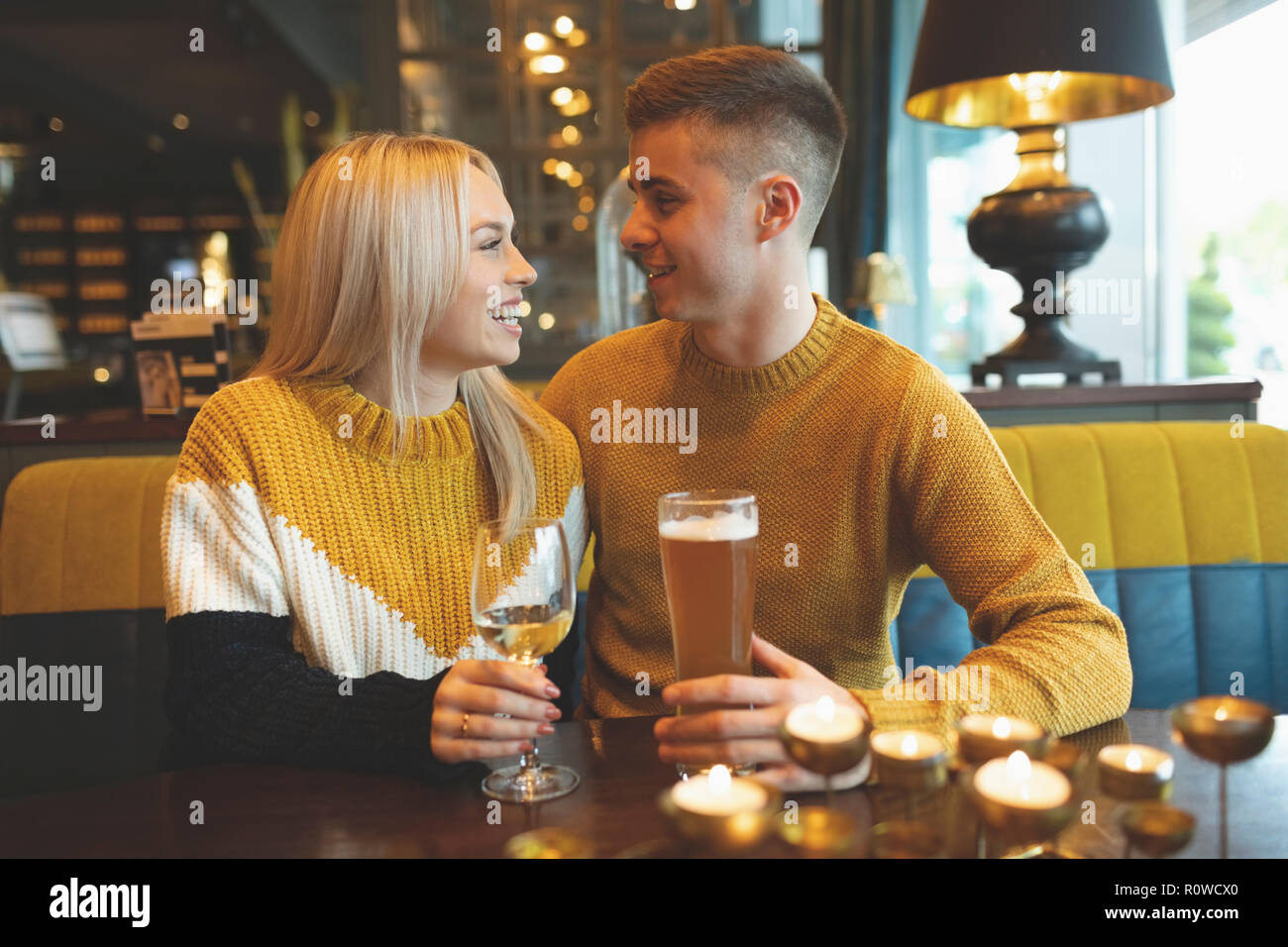Couple having drinks in restaurant Stock Photo - Alamy