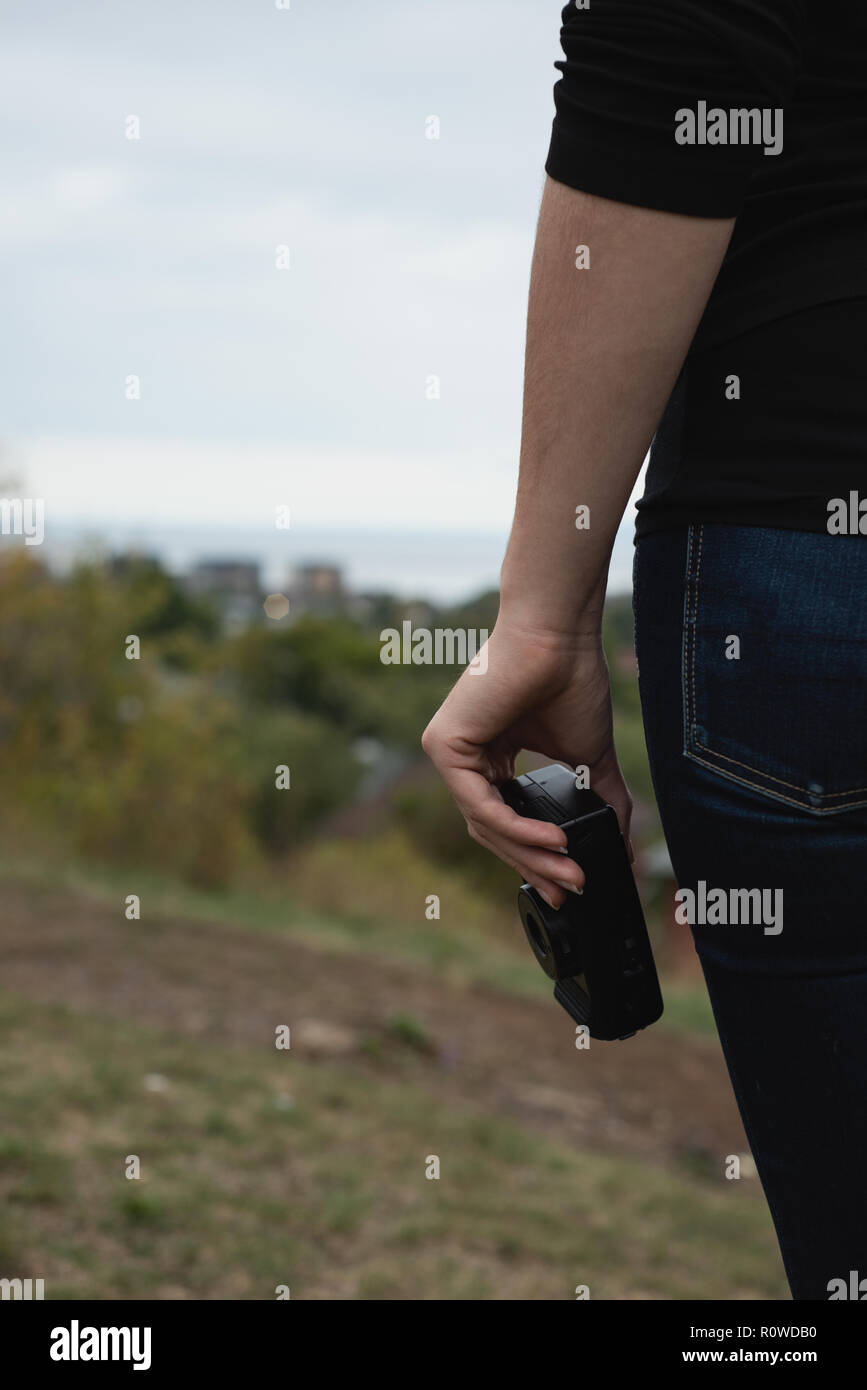 Woman standing alone on hill hi-res stock photography and images - Alamy