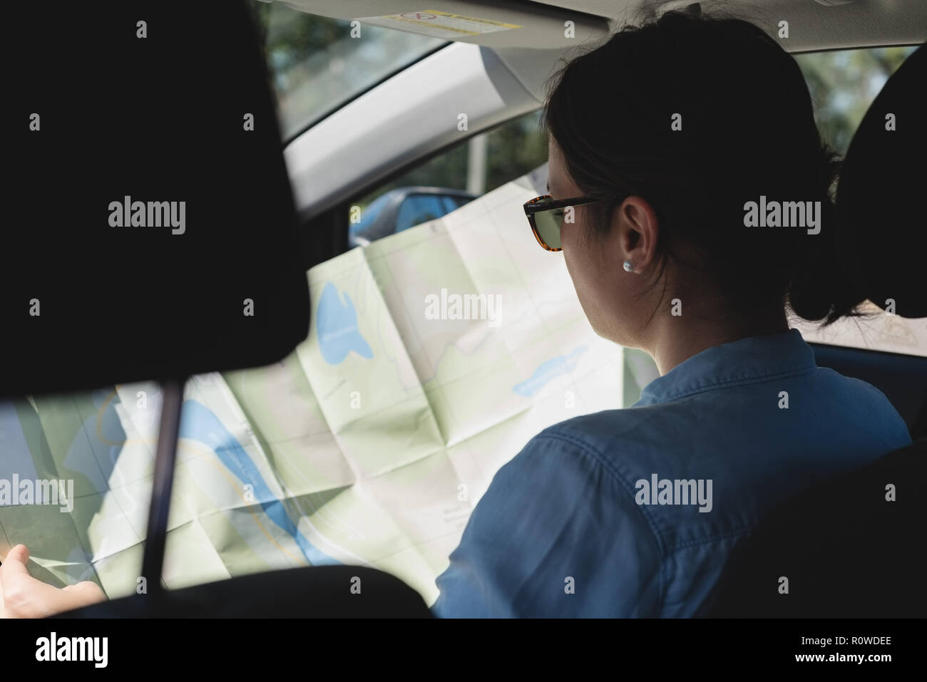 Woman looking at map in a car Stock Photo - Alamy