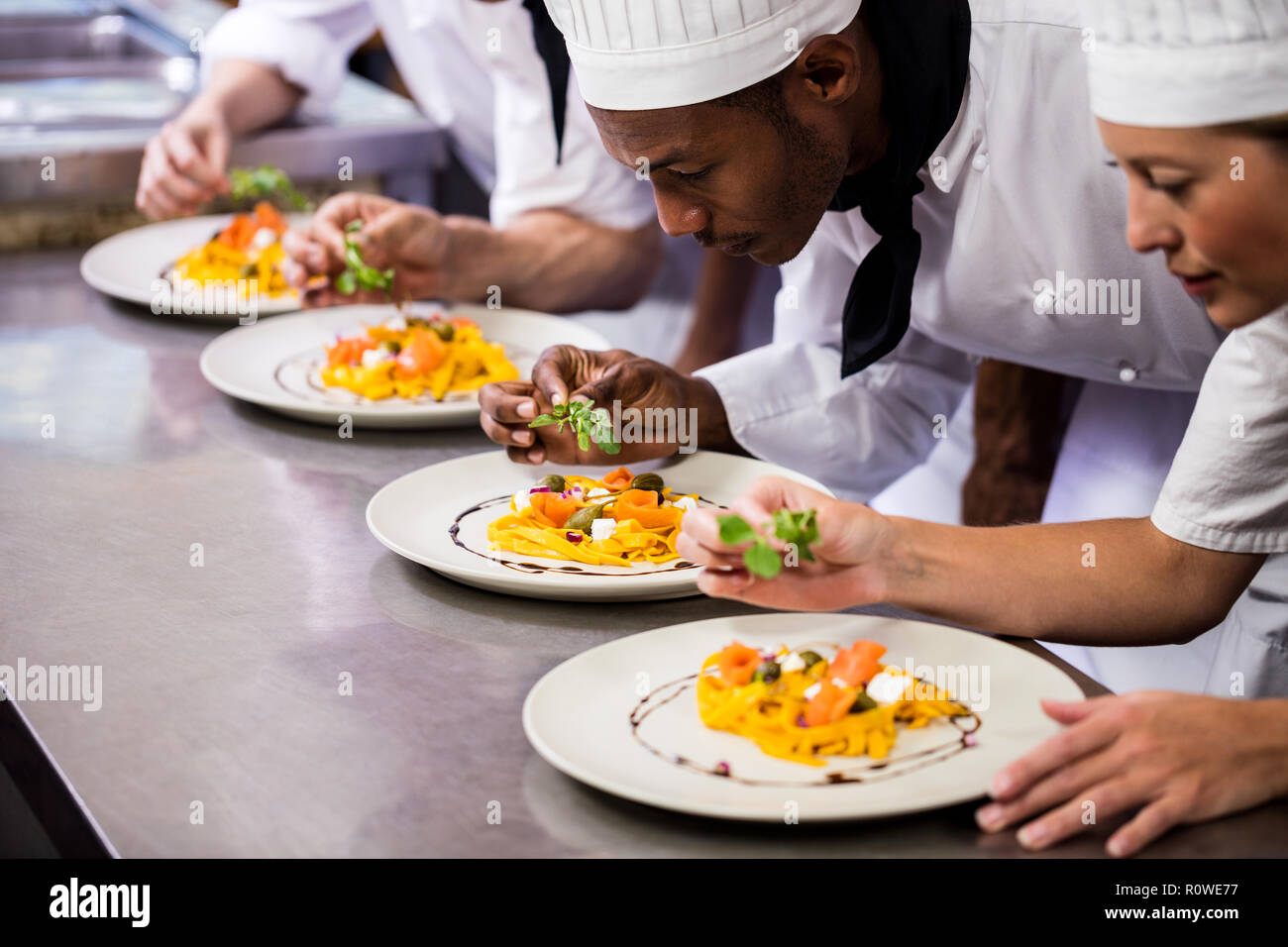 Chef holding food plates hi-res stock photography and images - Alamy