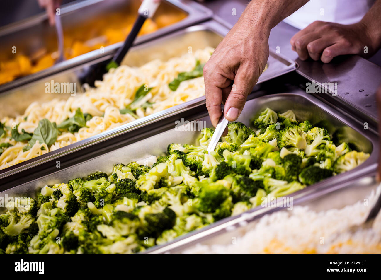 Chef standing at serving tray of food in kitchen Stock Photo - Alamy